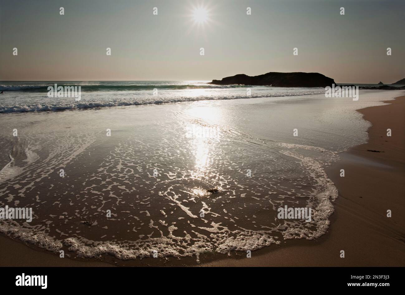 Gentle waves and surf lapping the sandy shore at Constantine Bay Beach ...