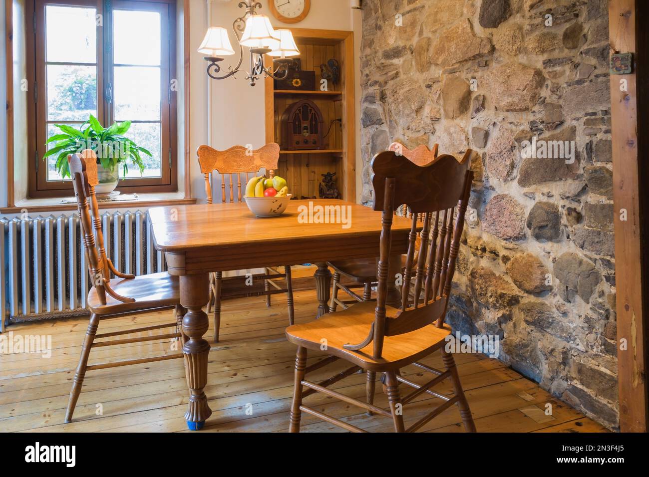 Antique wooden breakfast table with press back chairs in kitchen with ...