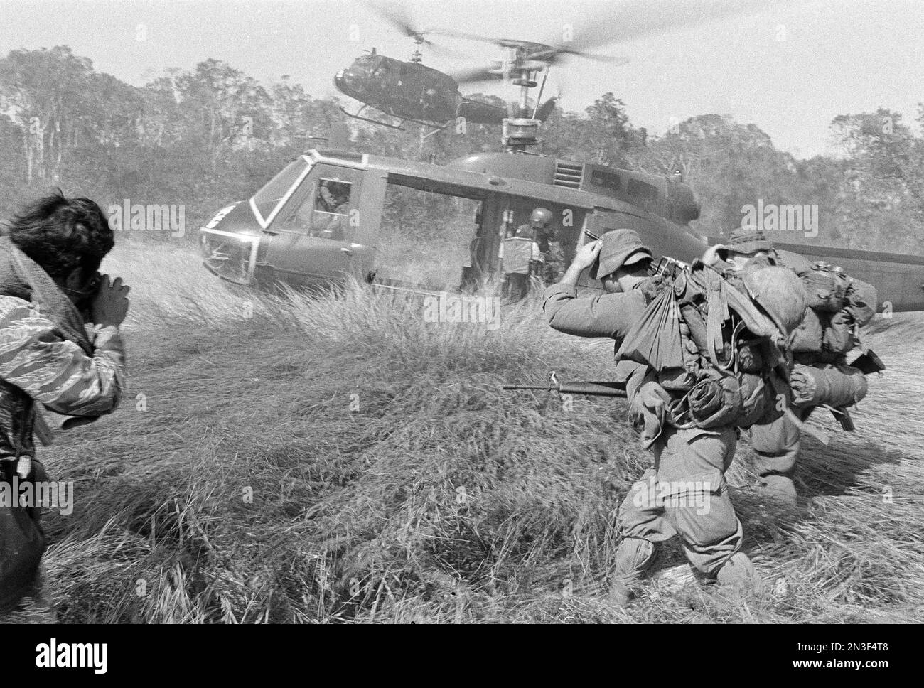 Two soldiers from the First Air Cavalry Division move toward a ...