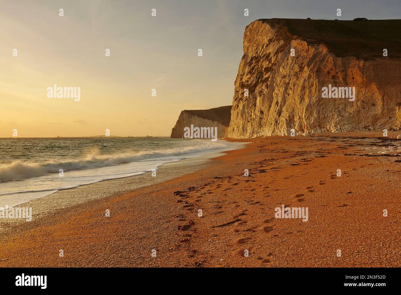 Footprints in the sand and Limestone cliffs near Durdle Door looking ...