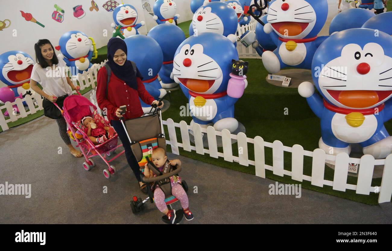 Visitors walk by life-siza Japanese popular anime character, Doraemon ...