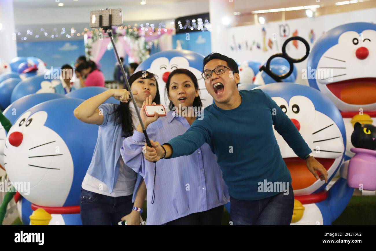Visitors pose for selfies with life-siza Doraemon, Japanese popular ...