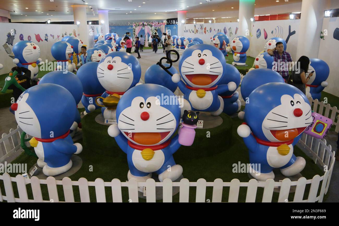Visitors walk by life-siza Japanese popular anime character, Doraemon ...