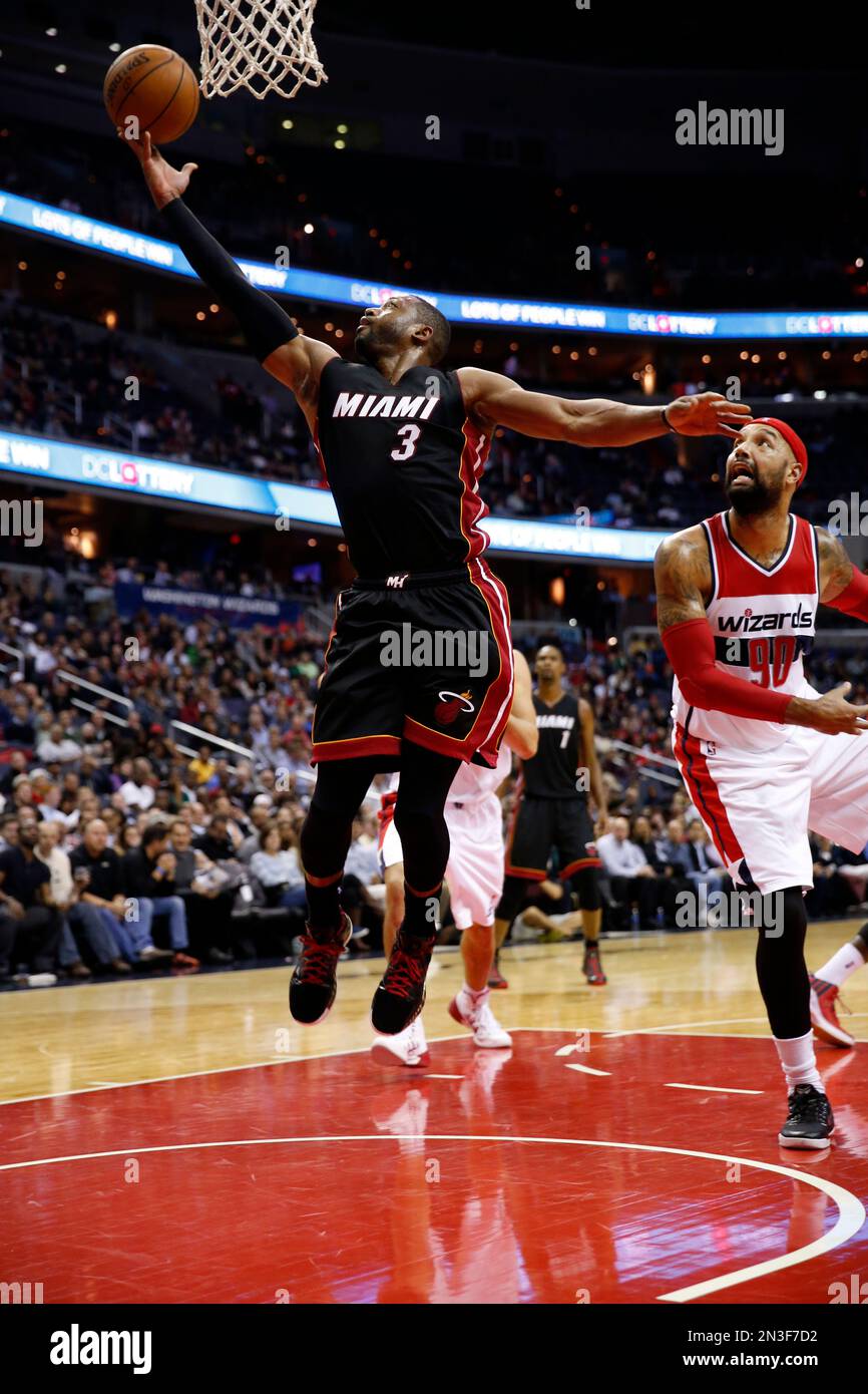 Miami Heat guard Dwyane Wade (3) shoots as he drives past Washington ...
