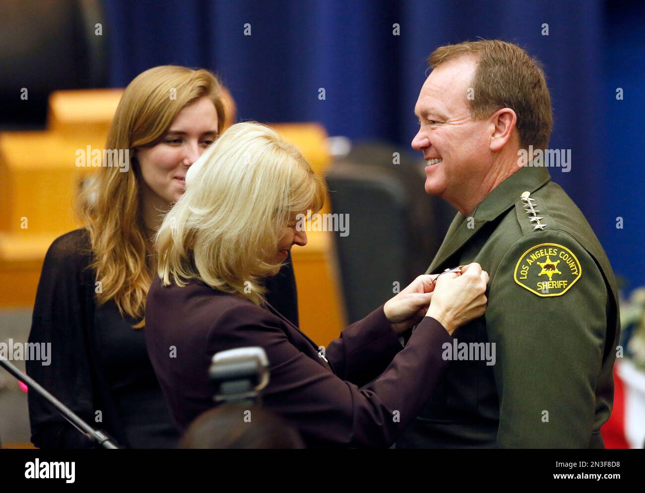 Sheriff Jim McDonnell, right, gets his new Sheriff's badge by his wife ...