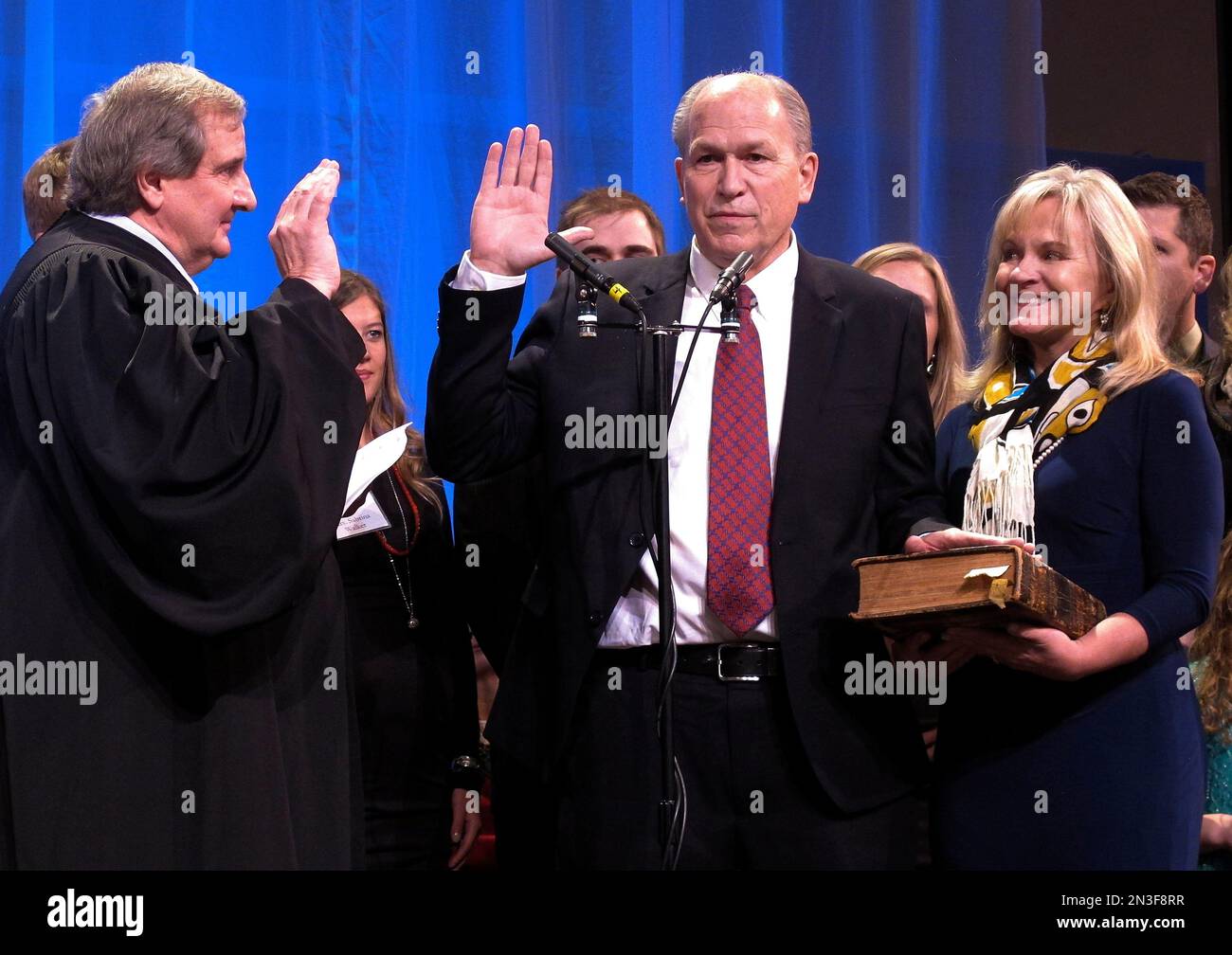 Bill Walker, center, is sworn in as Alaska's new governor as Alaska ...