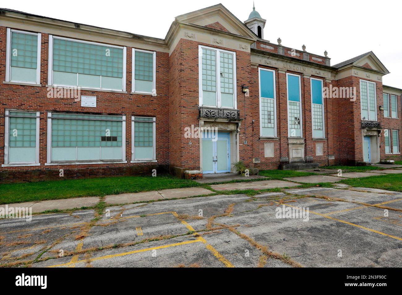 In this Thursday, Oct. 23, 2014 photo, an abandoned school is fenced ...