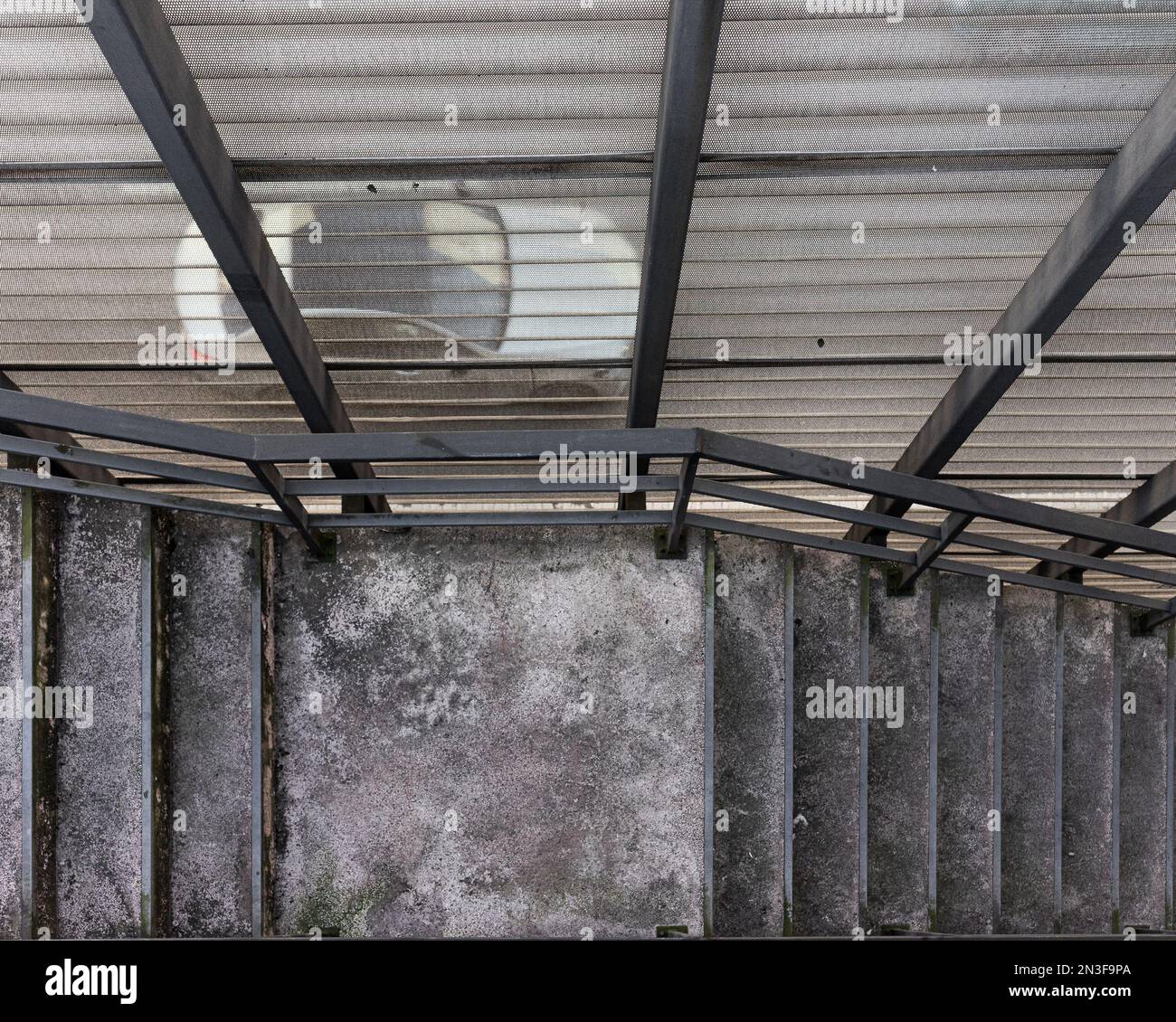 from the top of the stairway we see through the iron net cars speeding ...