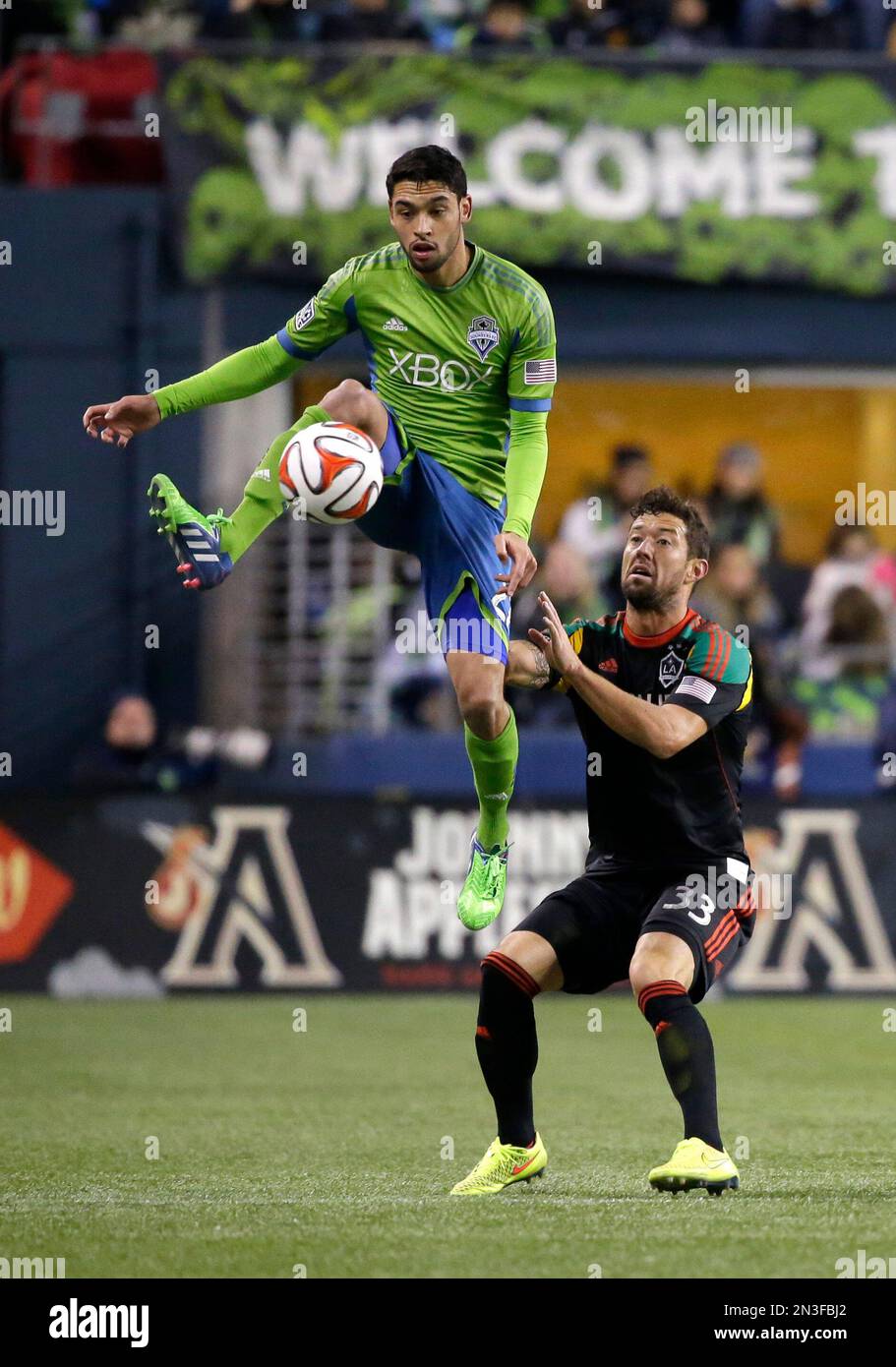 Seattle Sounders midfielder Lamar Neagle, left, leaps above Los Angeles ...