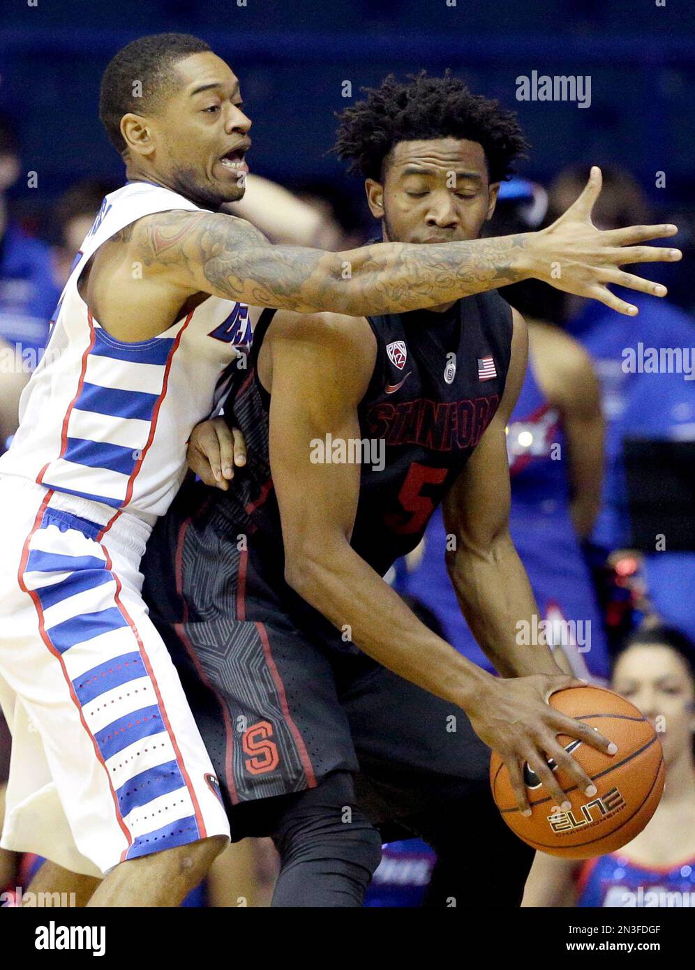 DePaul guard Aaron Simpson (15) guards Stanford guard Chasson Randle (5 ...