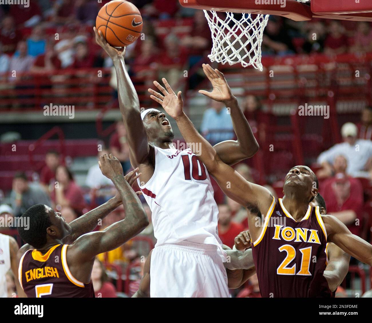 Arkansas' Bobby Portis (10) reaches up for the basket as Iona's A.J ...