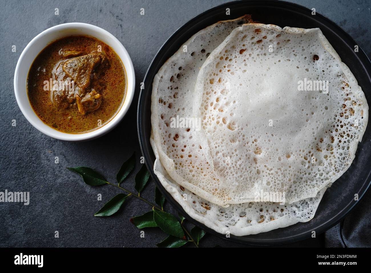 Kerala breakfast appam or palappam with mutton curry Stock Photo - Alamy