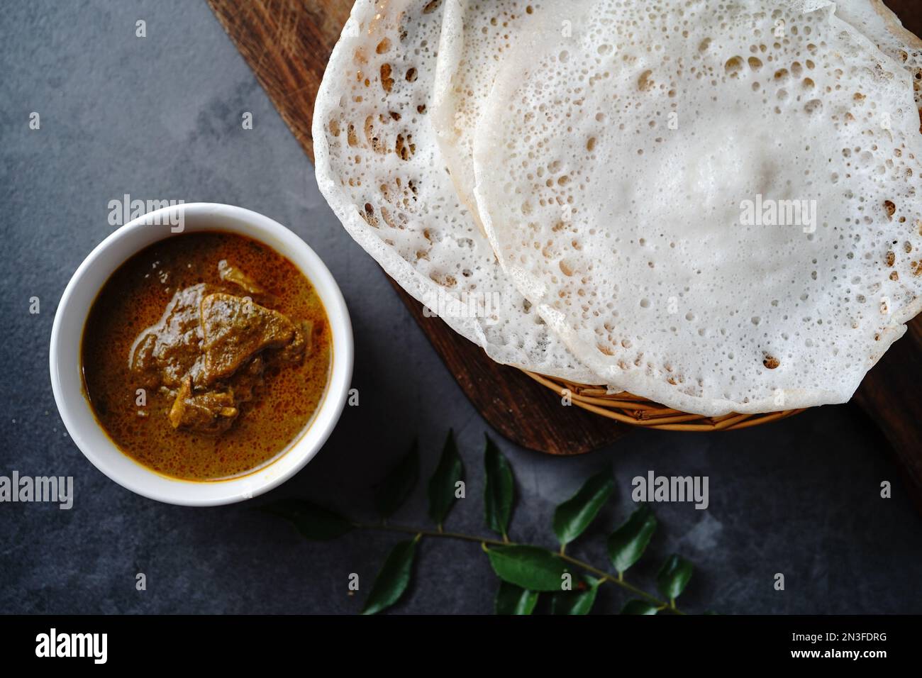 Kerala breakfast appam or palappam with mutton curry Stock Photo - Alamy