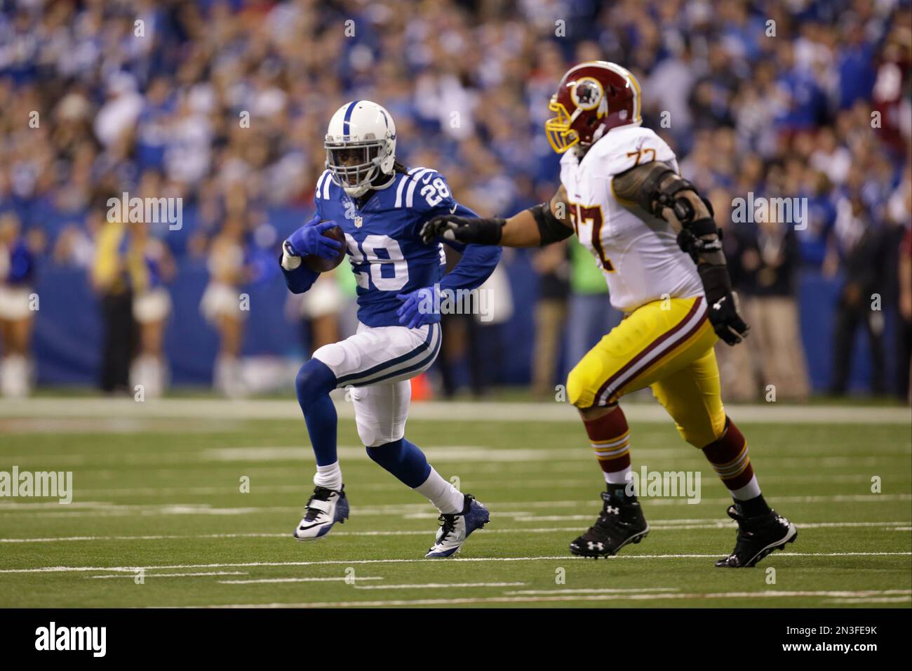 Indianapolis Colts cornerback Greg Toler, left, runs past Washington Redskins guard Shawn Lauvao ...