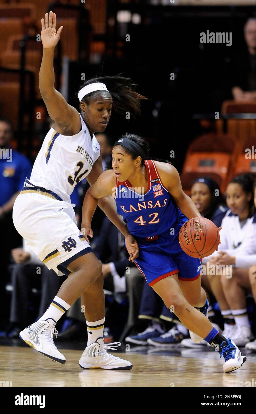 Kansas' Natalie Knight (42) drives past Notre Dame's Markisha Wright ...