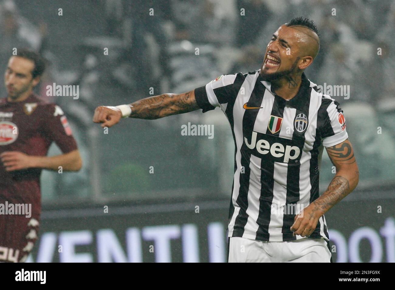 Juventus' Arturo Vidal, right, celebrates after scoring during a Serie ...