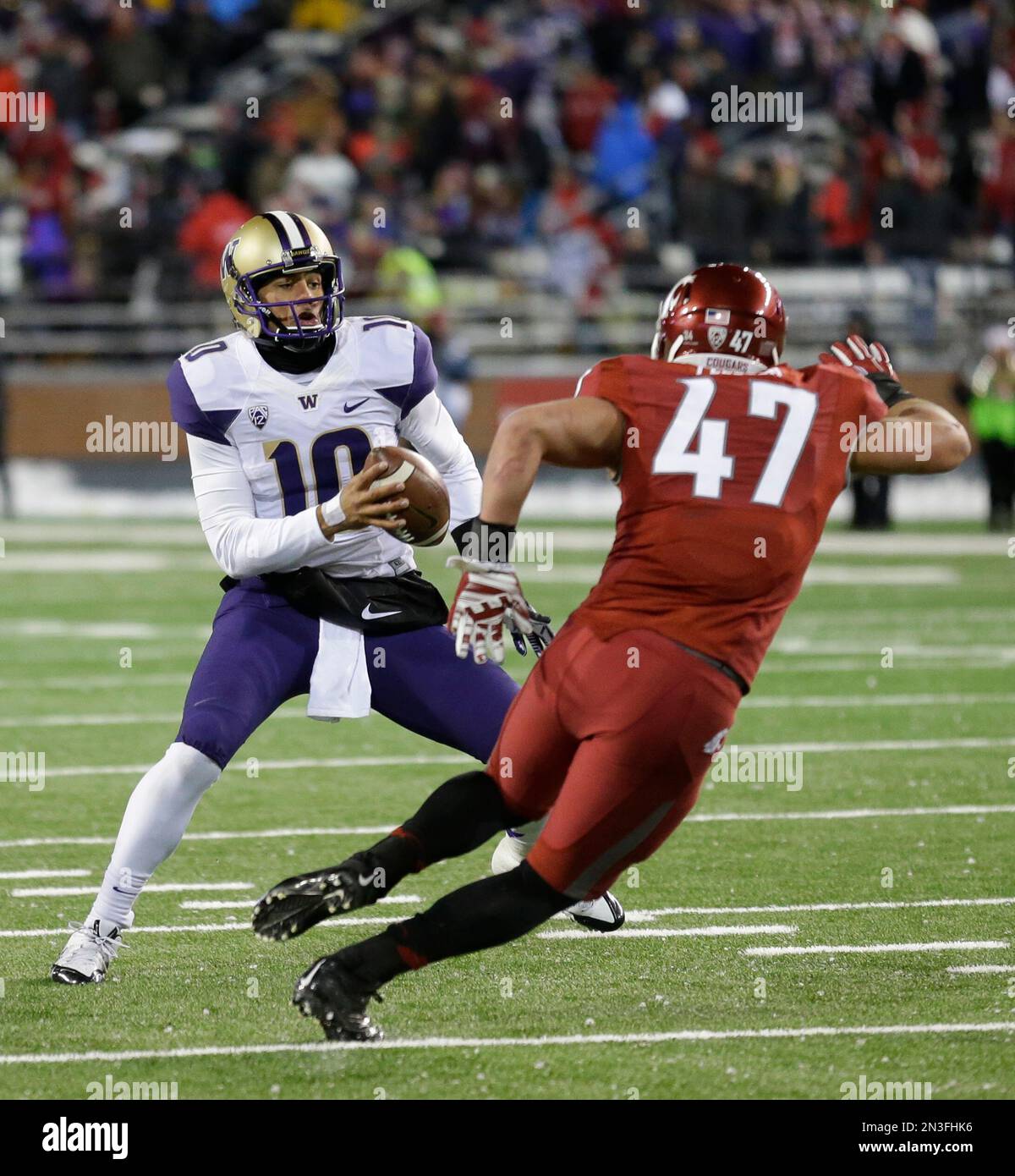 Washington quarterback Cyler Miles (10) tries to avoid Washington State ...