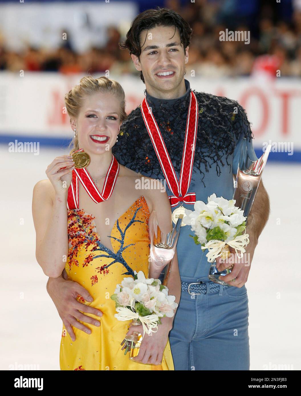 Winner Kaitlyn Weaver and Andrew Poje of Canada pose for photographers during a awarding ...