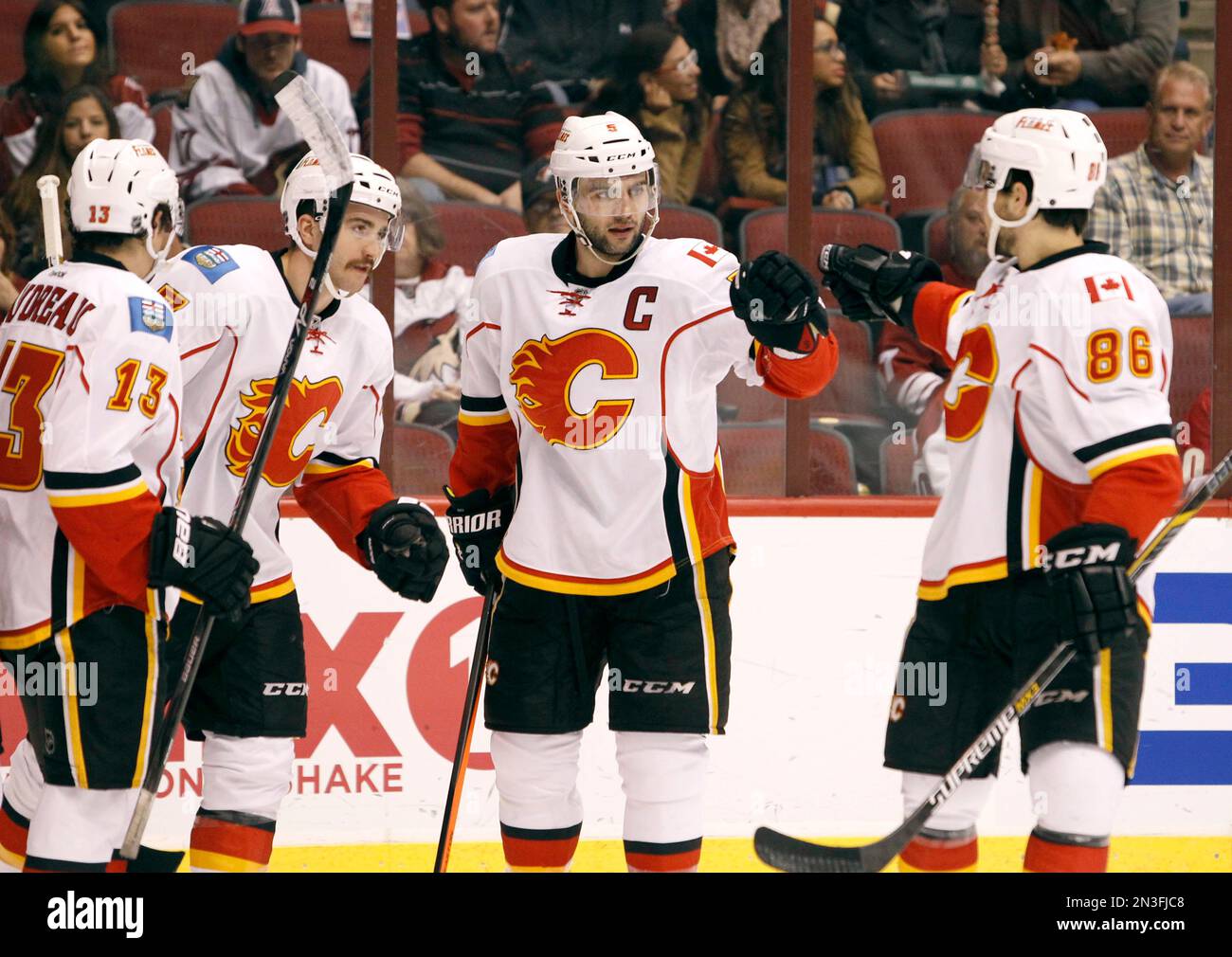 Calgary Flames' Johnny Gaudreau (13), T.J. Brodie, center left, Mark ...