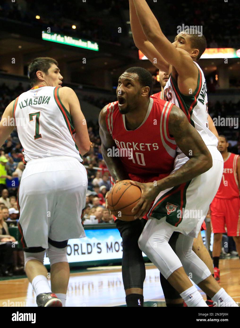 Houston Rockets forward Tarik Black, center, drives to the basket ...