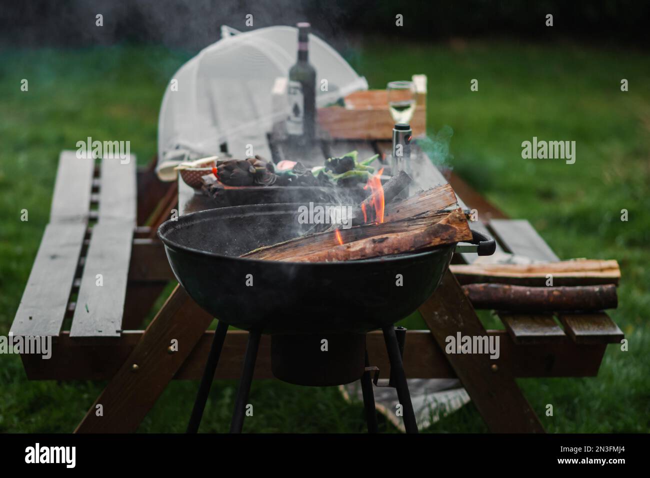 The smoking brazier of a round form. Firewood flares up in the brazier ...