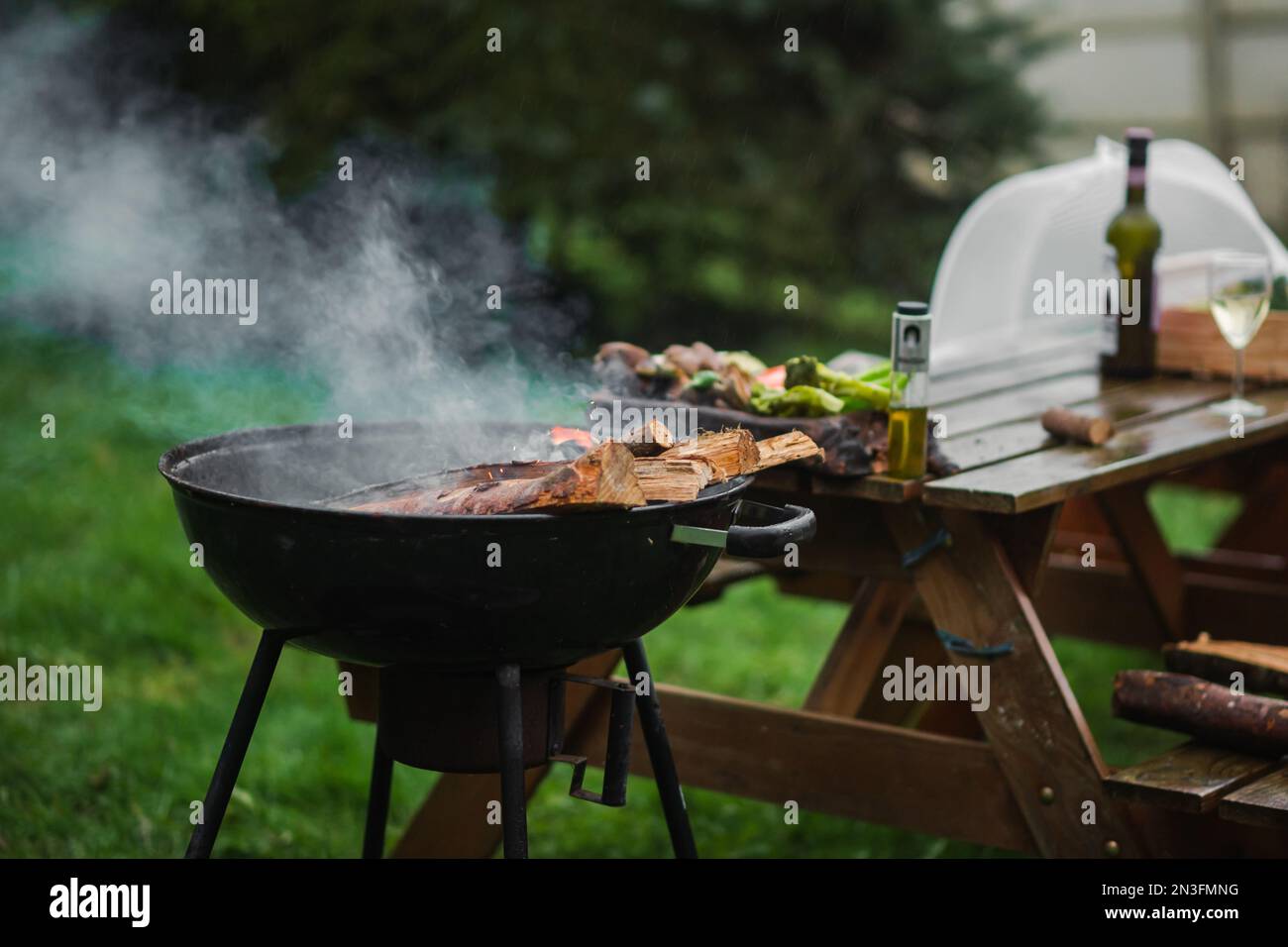 The smoking brazier of a round form. Firewood flares up in the brazier ...
