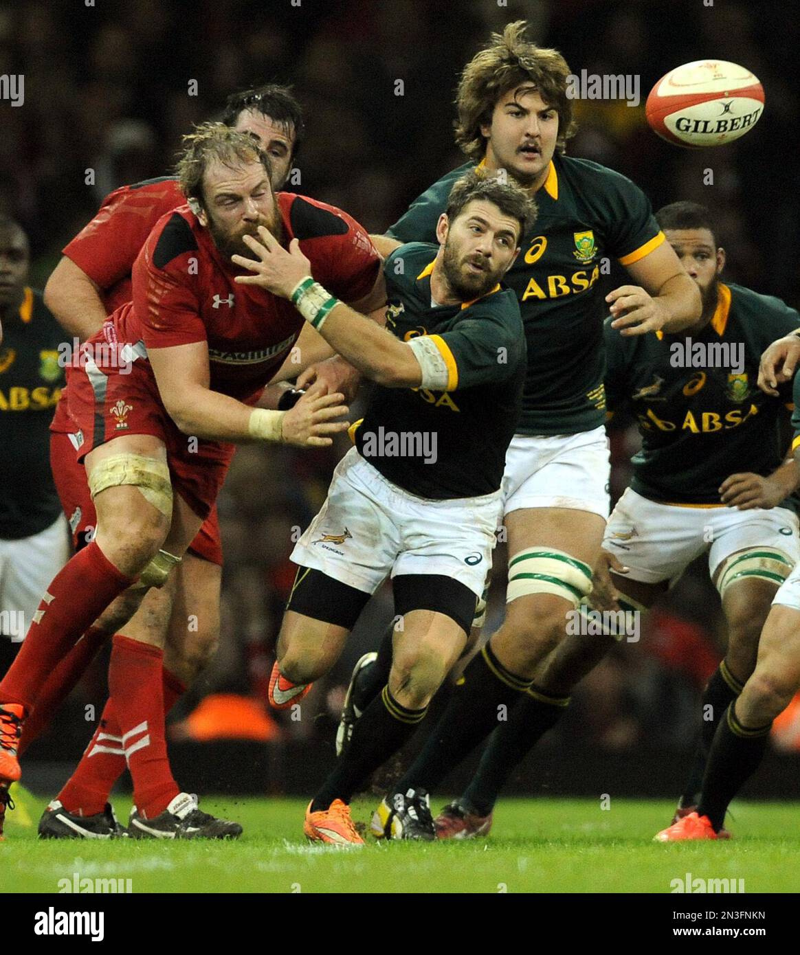 South Africa's Willie le Roux holds back Wales' Alun Wyn Jones, left ...
