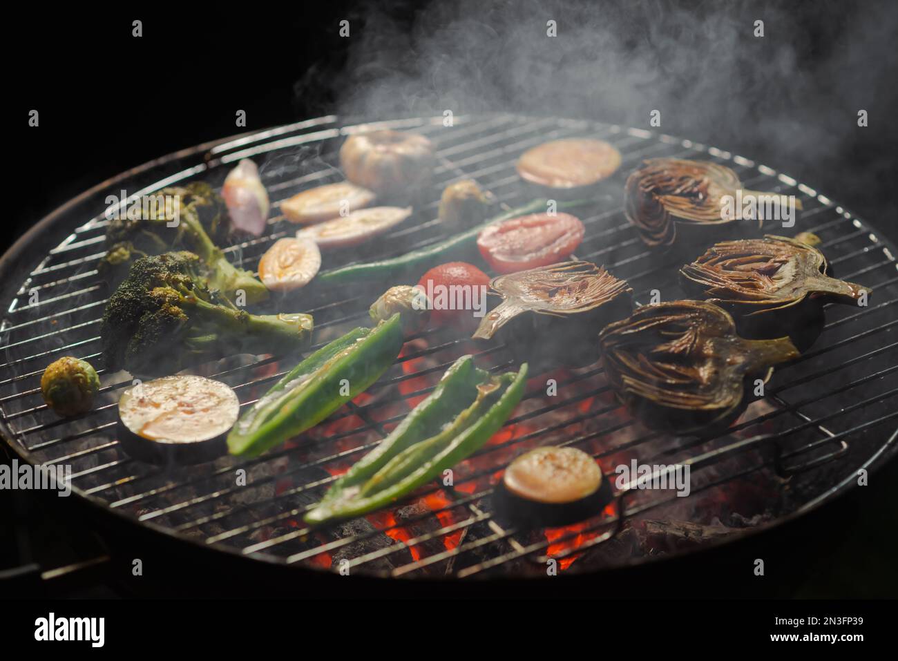 Green grilling. Various vegetables - artichokes, peppers, eggplants are ...