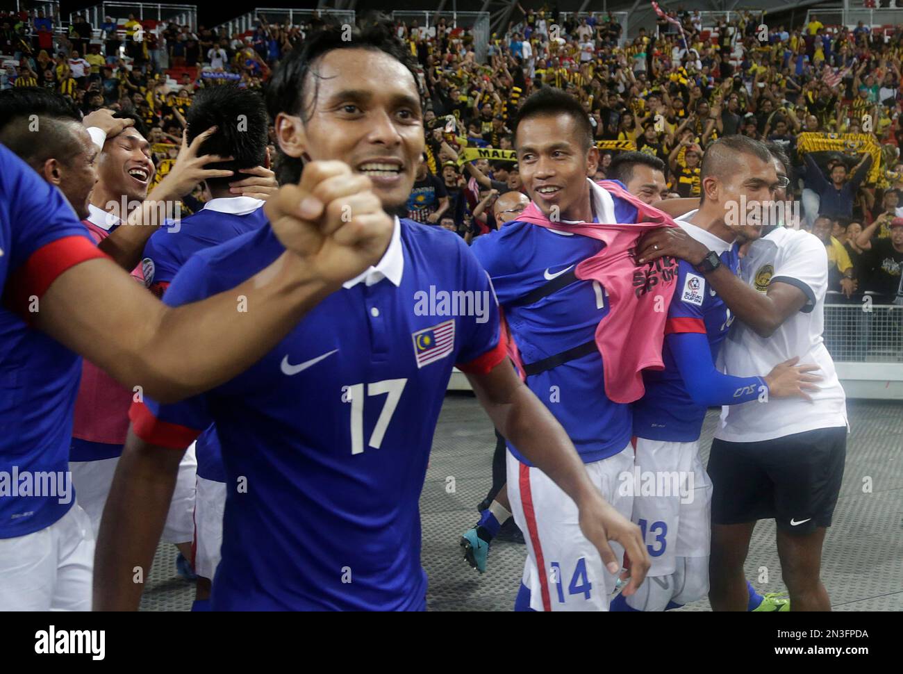 The Malaysian team celebrate after Malaysia's Indra Putra Mahayuddin ...