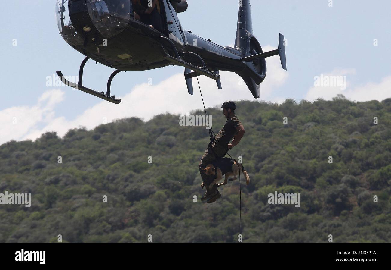 In this photo taken Wednesday, Nov. 26 2014 a handler and his dog ...
