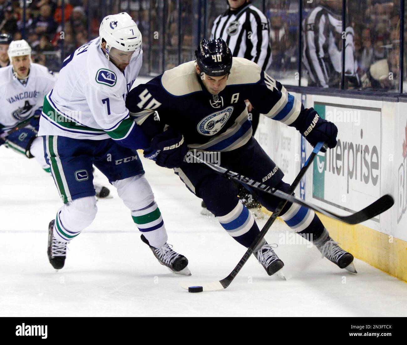 Columbus Blue Jackets' Jared Boll, right, works for the puck against ...