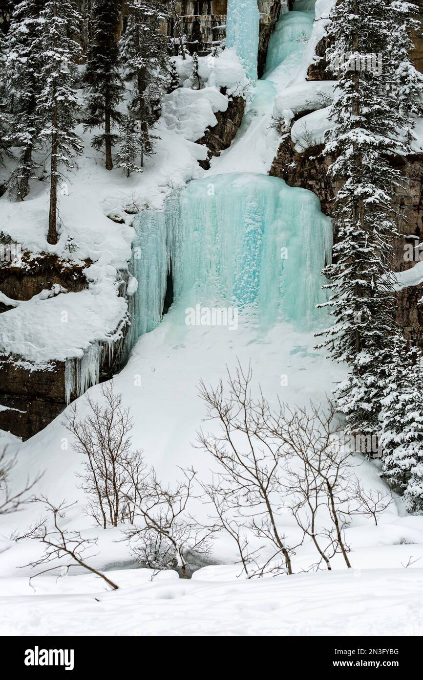 Ice falls on a cliff on a snowy mountainside in Banff National Park ...