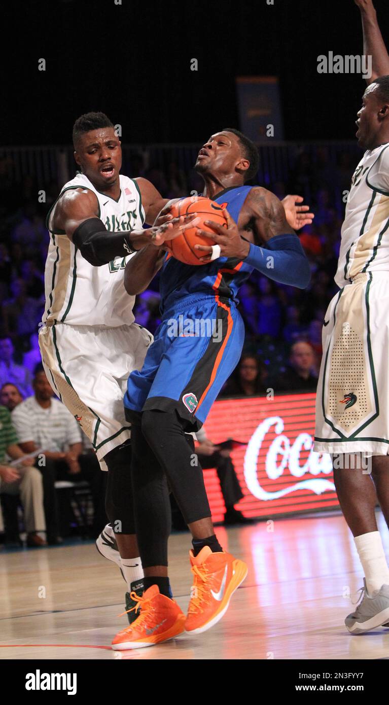 Florida's Michael Frazier II (20) goes up against UAB's Tosin Mehinti ...