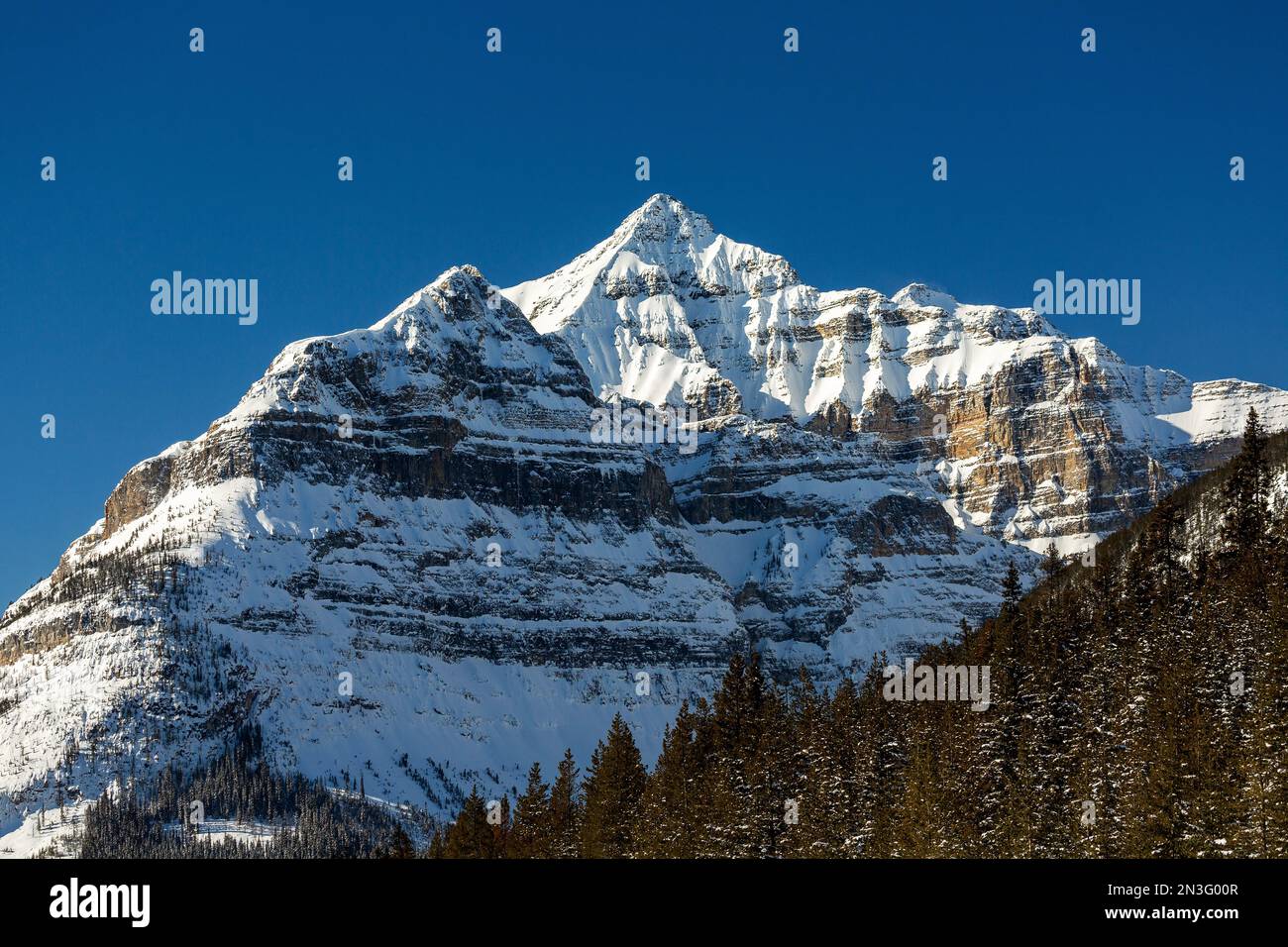 Snow-covered mountain with bright blue sky in Banff National Park; Lake ...