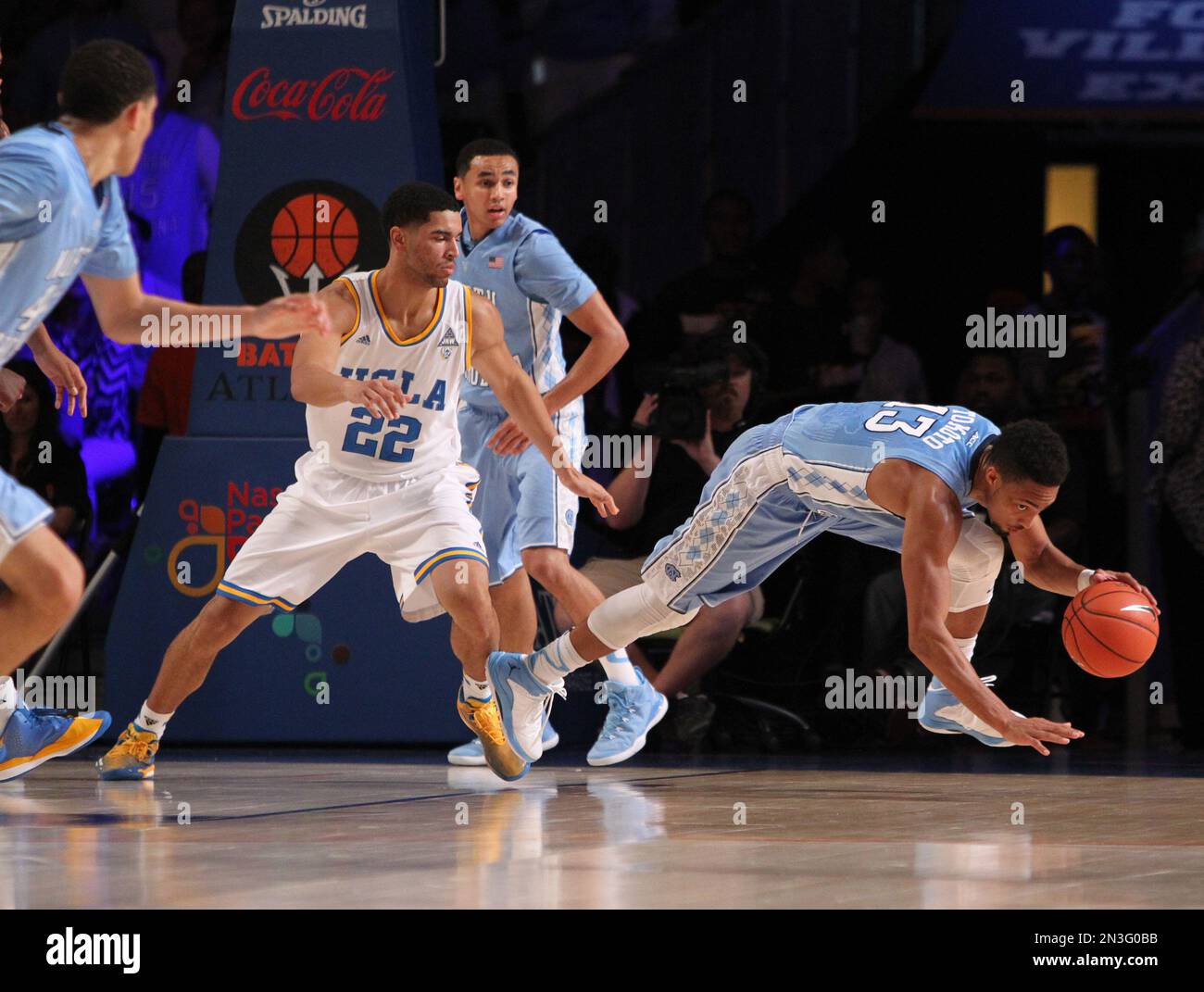 UNC's J.P. Tokoto (13) recovers the ball and gets away from UCLA's Noah ...