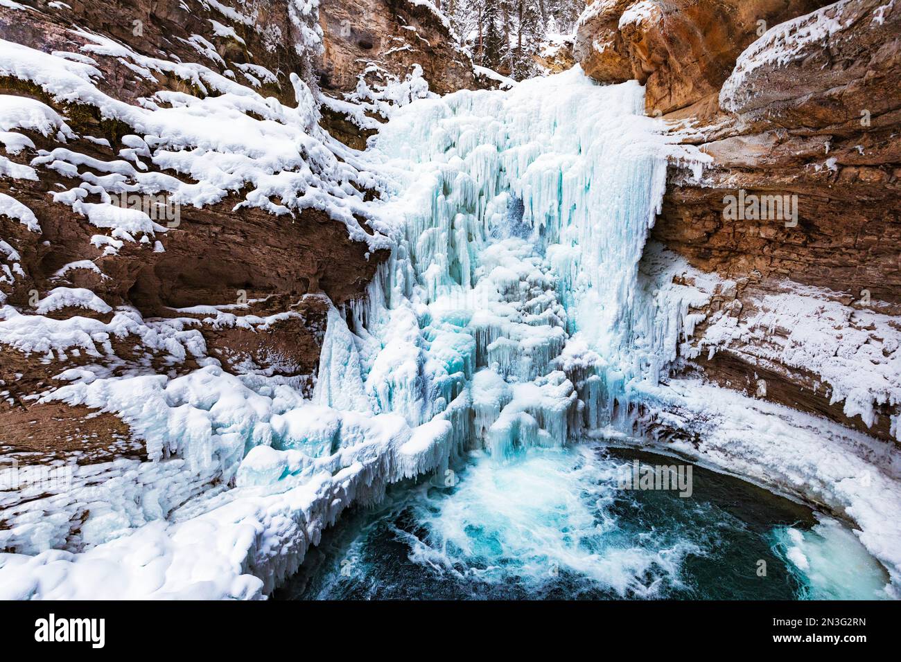 Frozen waterfall and pool at Johnston Canyon during winter in Banff ...