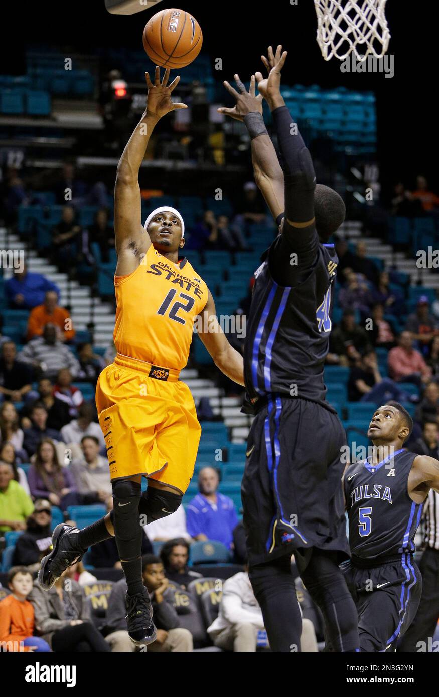 Oklahoma State guard Anthony Hickey Jr. shoots against Tulsa forward D ...
