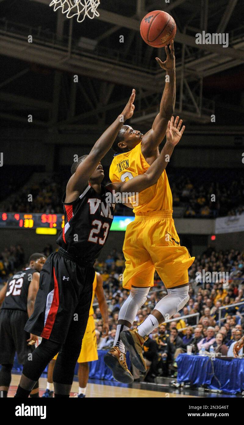 West Virginia's Juwan Staten (3) shoots a layup as VMI's Tim Marshall ...