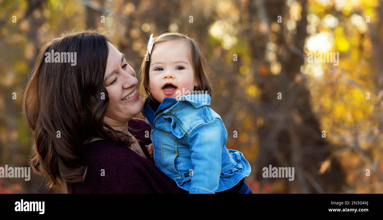 Portrait of a mother and her baby girl with Down Syndrome spending ...