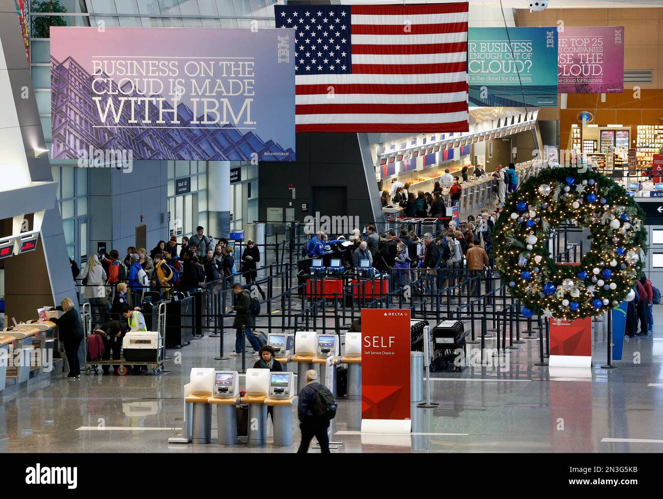 Passengers line up at the security checkpoint in terminal A at Logan ...