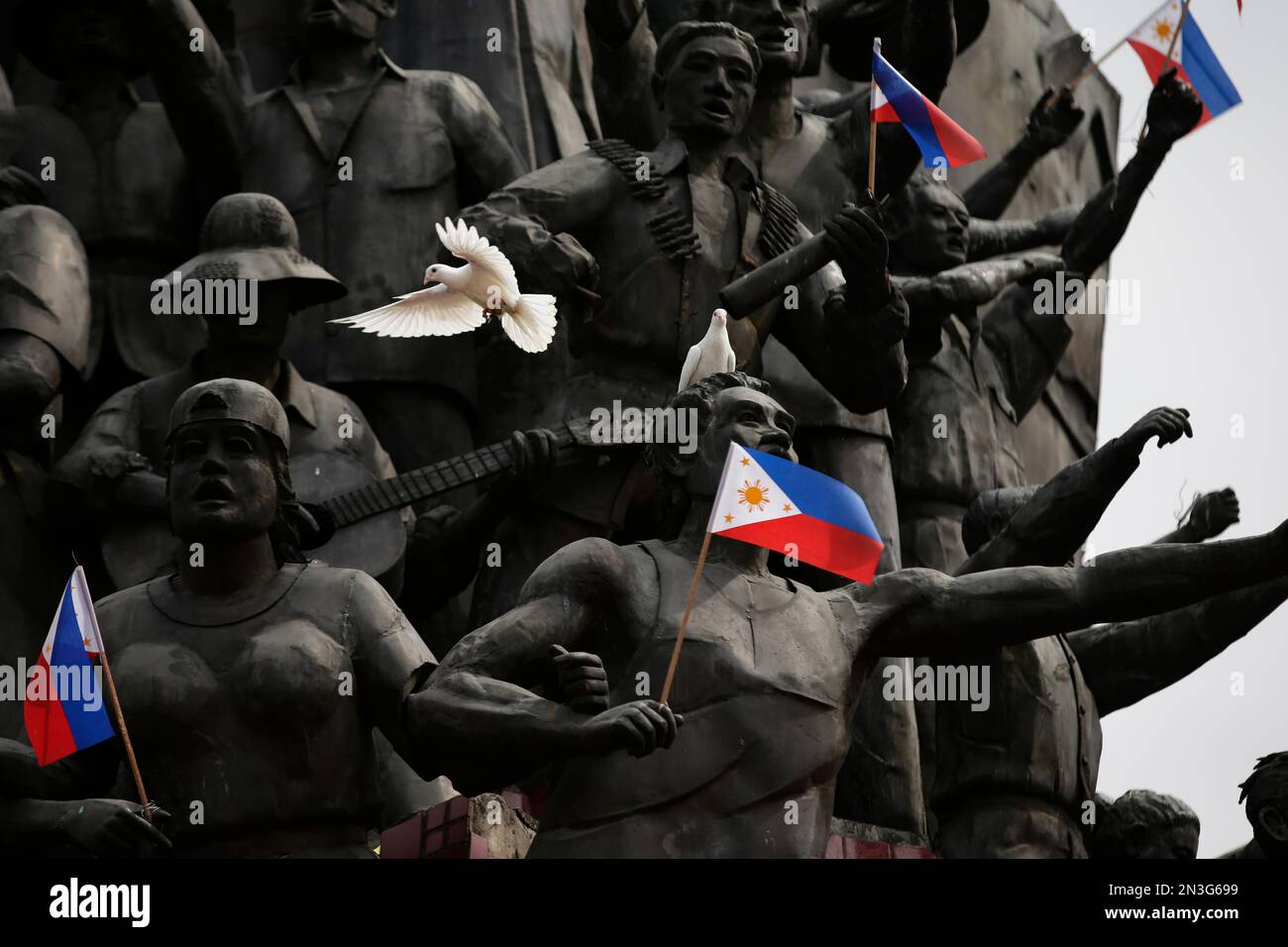 Pigeons gather at the People Power monument during the celebration ...