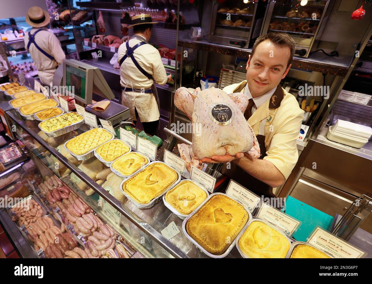 Danny Lidgate displays a turkey at his butchers shop in Holland Park in ...