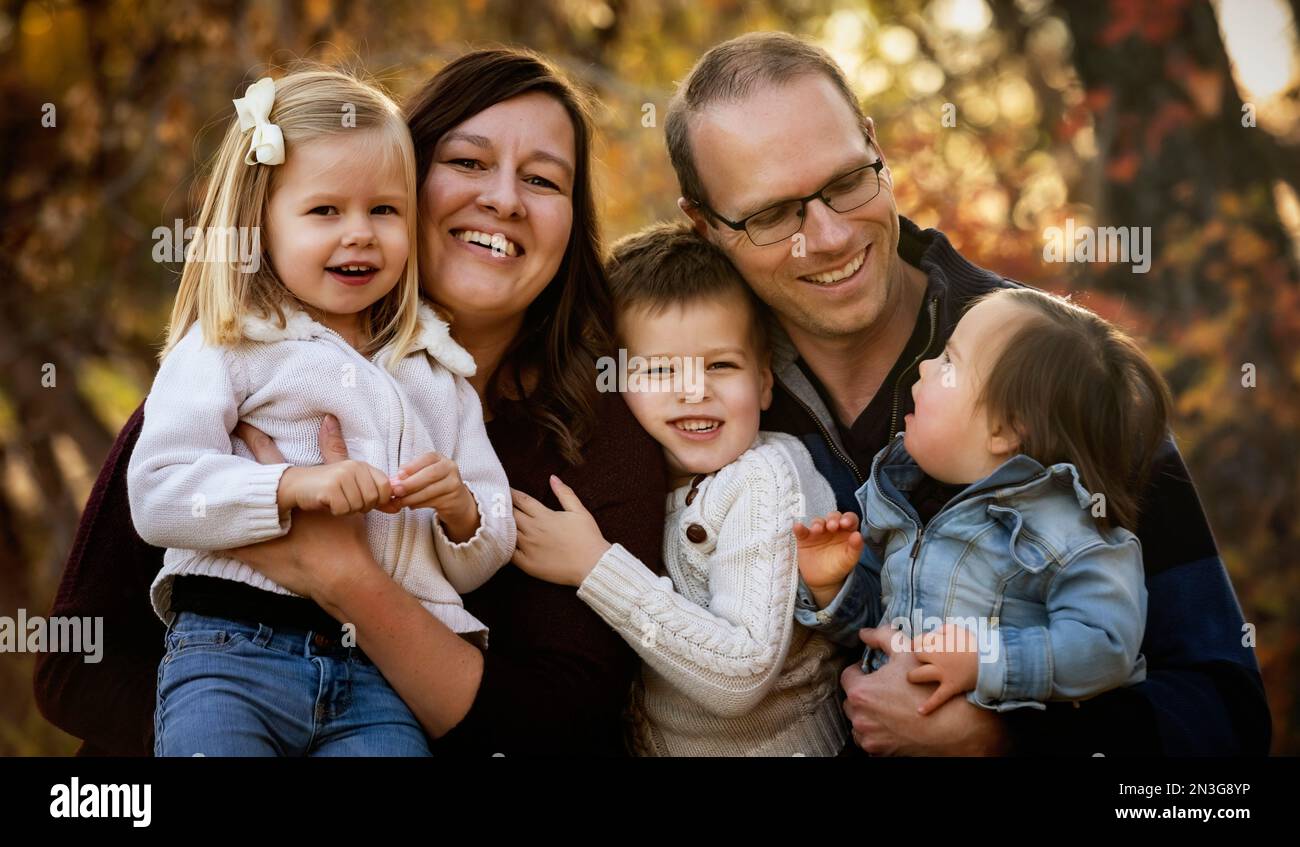 Portrait of a young family with three children, youngest daughter with ...