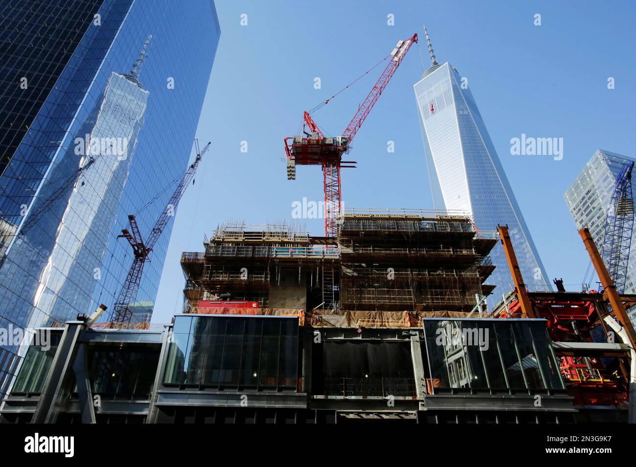 A construction crane works on top of the rising steel frame of Three ...
