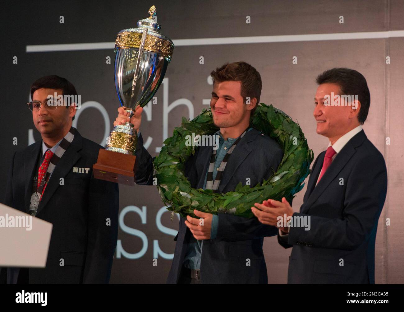 Norway's Magnus Carlsen shows his trophy at an award ceremony of the FIDE World Chess ...