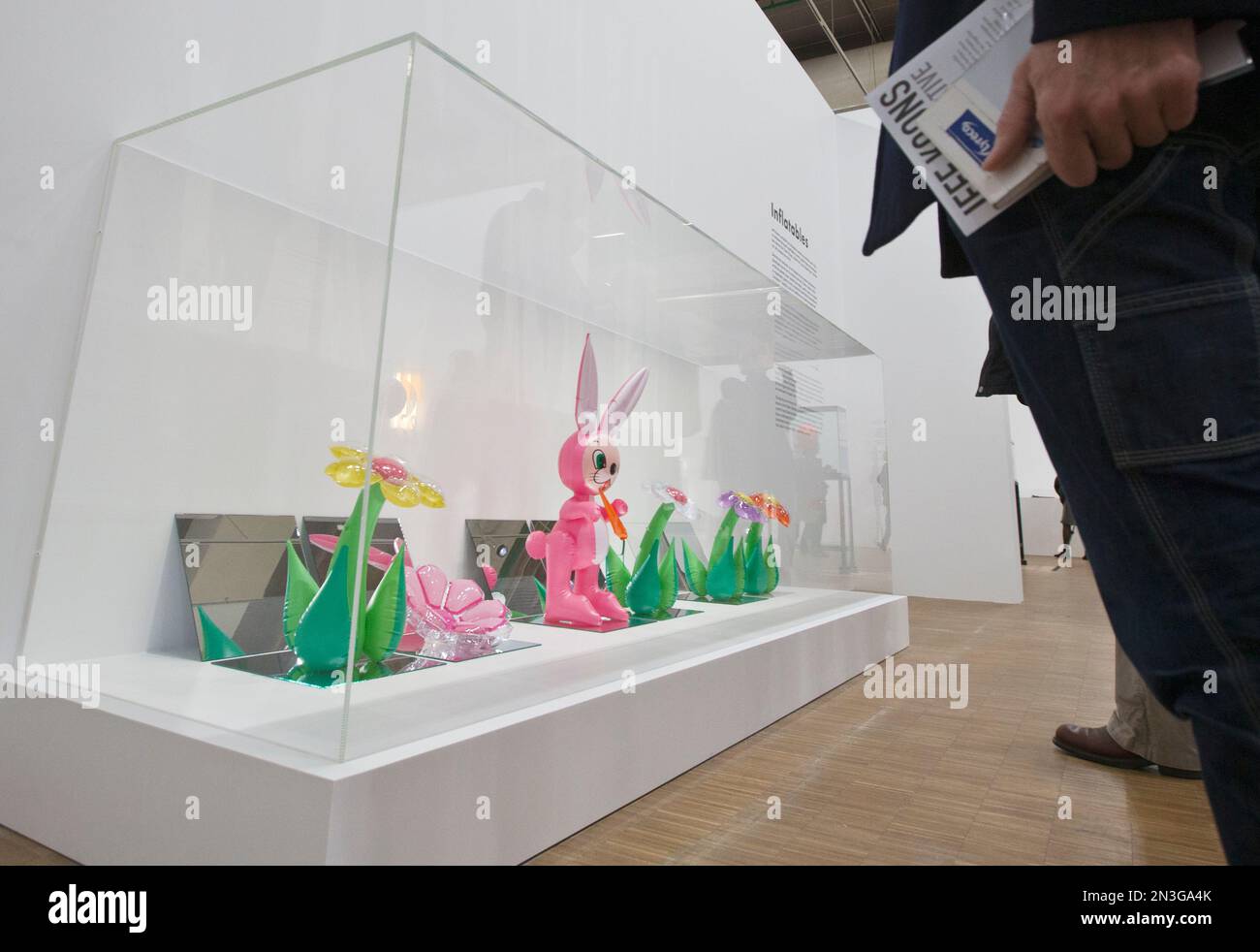 Visitors look at "Inflatable Flower and Bunny 1979 (Short Pink, Tall ...