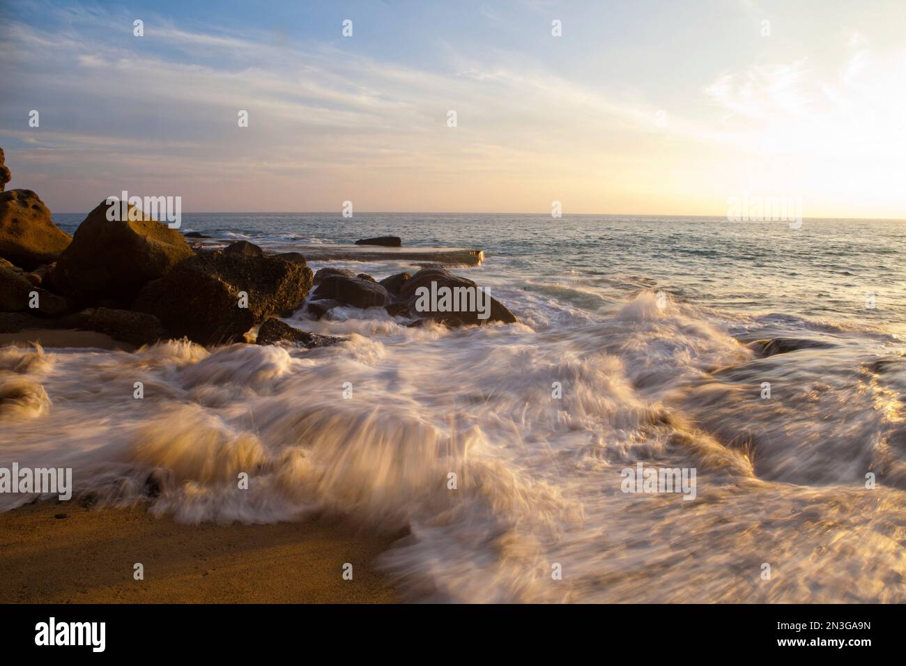 Waves break sea sunset hi-res stock photography and images - Alamy