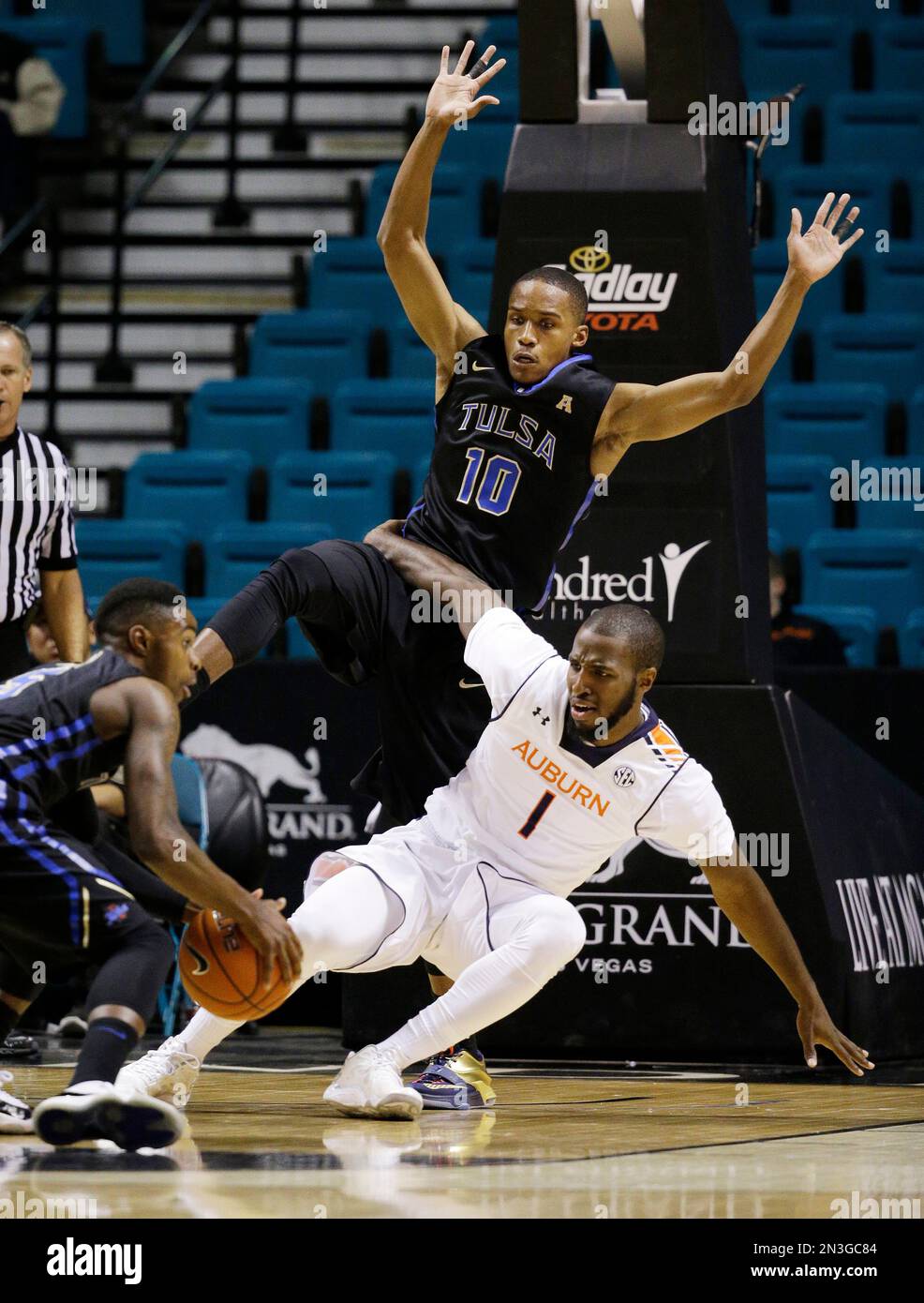 Auburn guard KT Harrell (1) falls into Tulsa guard James Woodard (10 ...