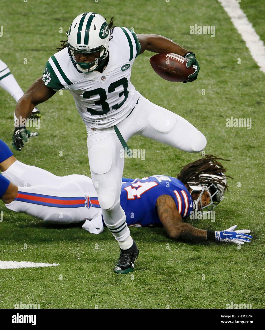 New York Jets running back Chris Ivory (33) leaps over Buffalo Bills ...