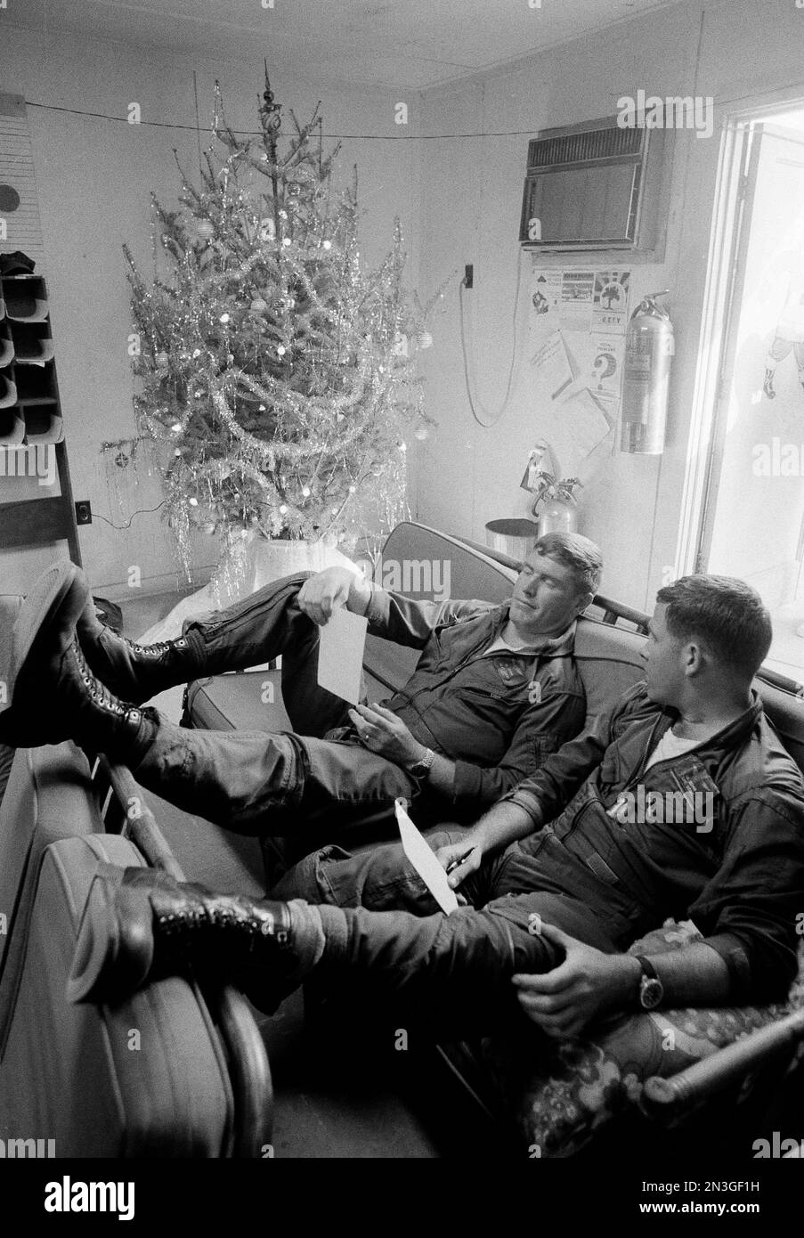 Two Marine aviators, Capt. John Bohn, right, and Lt. Ed Jobin, relax in ...